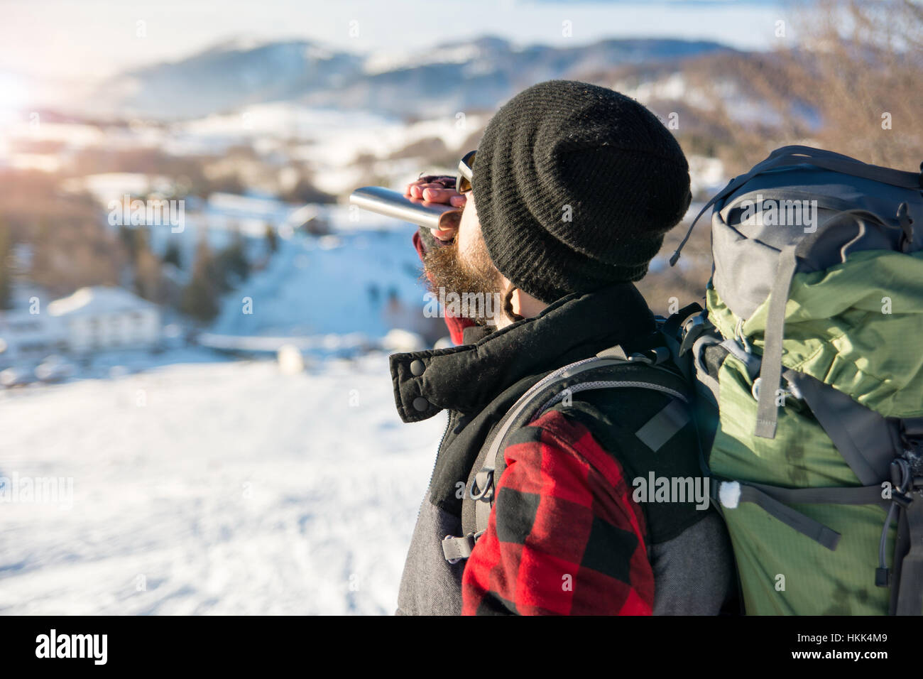 Man drinking from a hip flask on winter hiking trip Stock Photo - Alamy