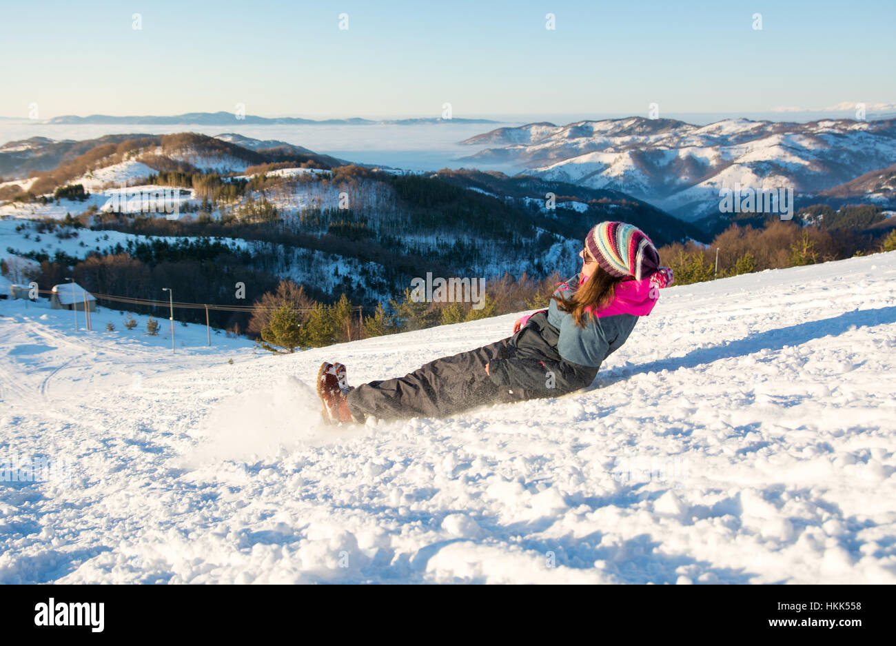 Girl falling down on the snowy mountain Stock Photo - Alamy