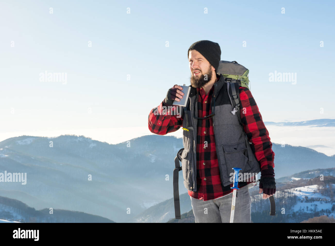 Man drinking from a hip flask on winter hiking trip Stock Photo - Alamy