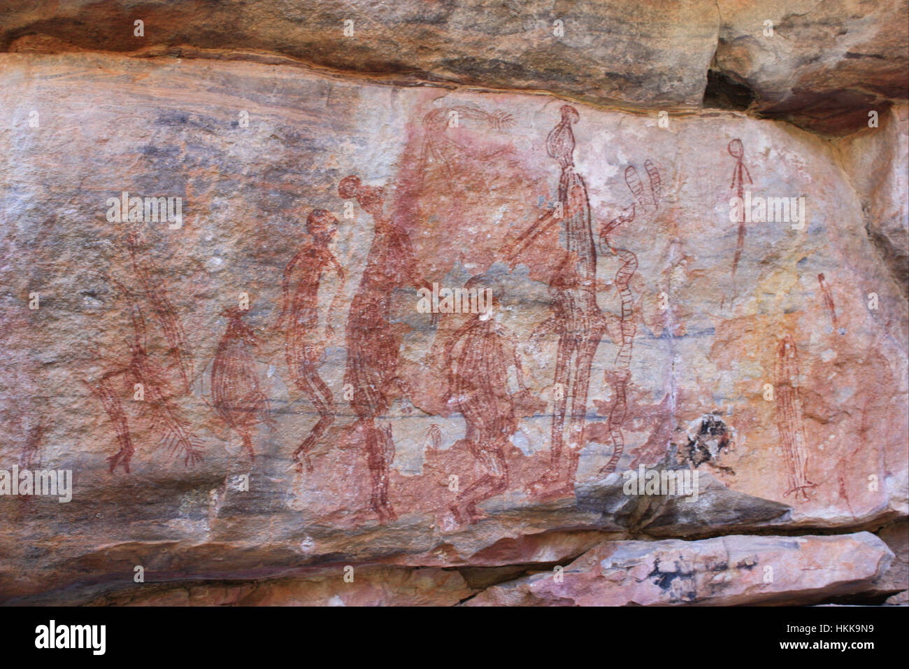This artwork depicts ancient human figures painted in red, possibly ...