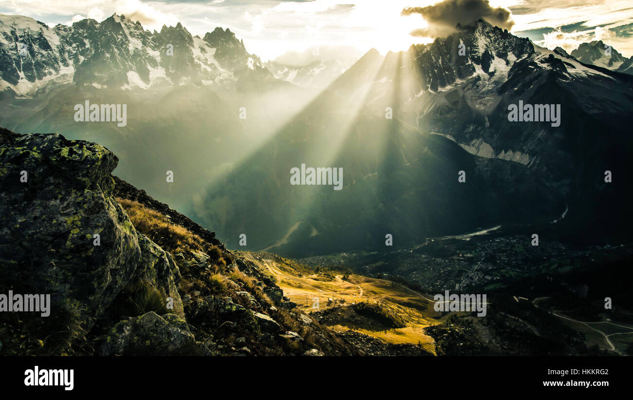 Sun rays from mountain peaks Stock Photo - Alamy