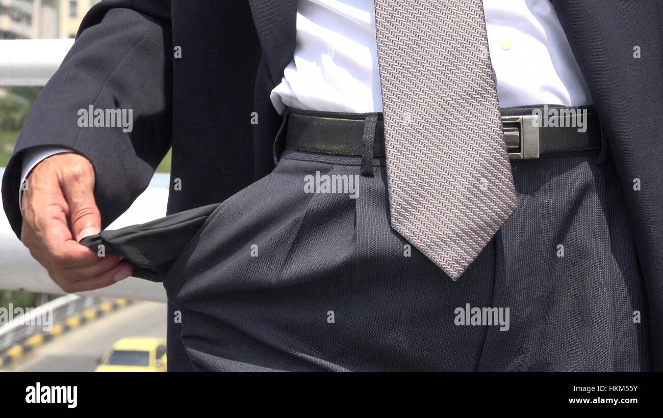 Poor Business Man With Empty Pockets Stock Photo - Alamy