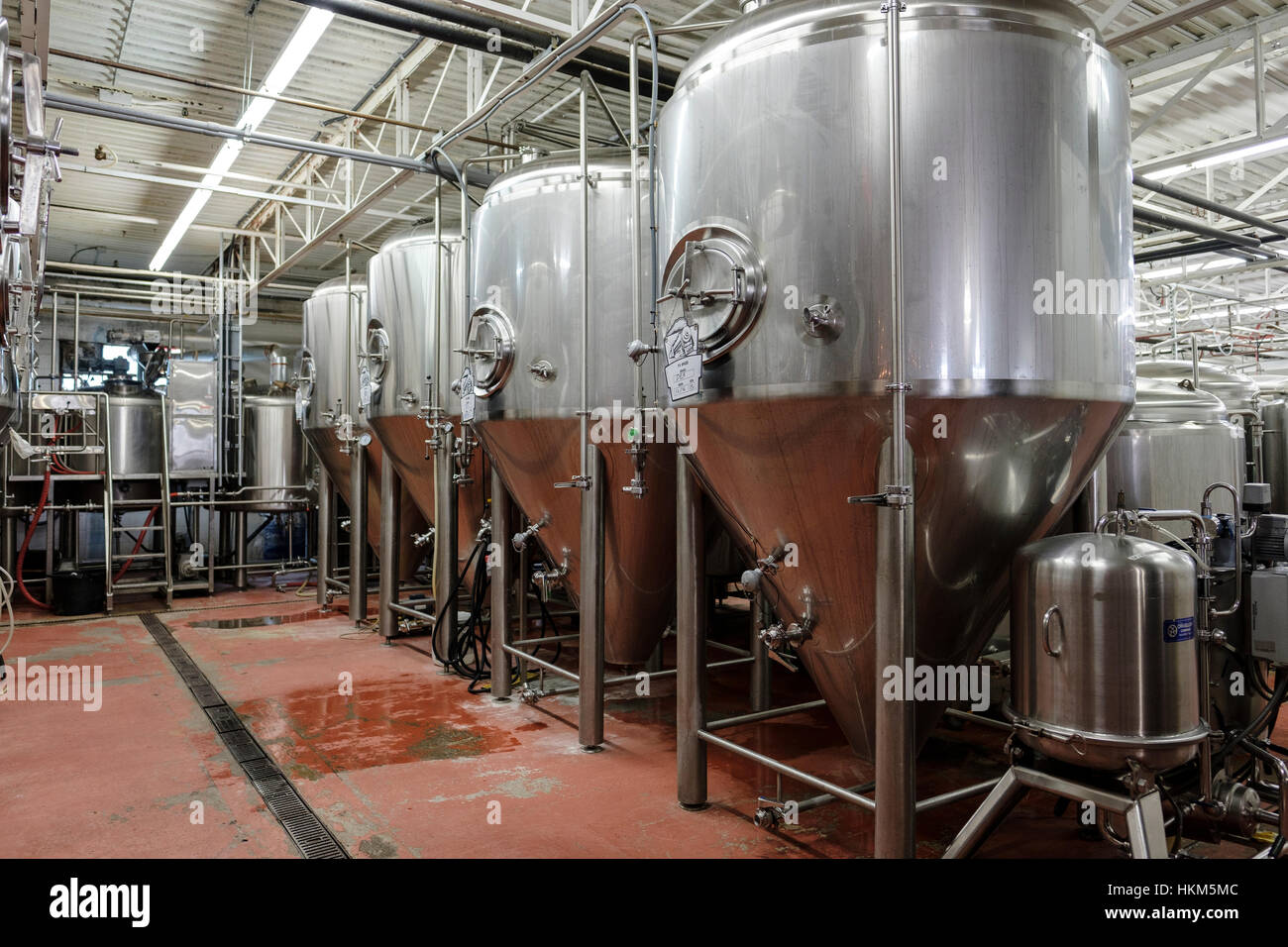 Several stainless steel commercial beer tanks used for fermenting beer ...
