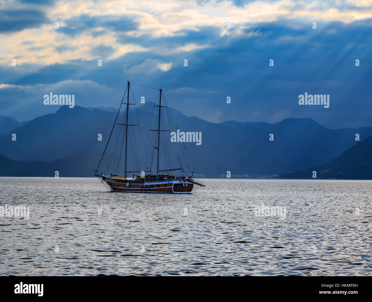 Vintage ship sailing with sun rays Stock Photo - Alamy