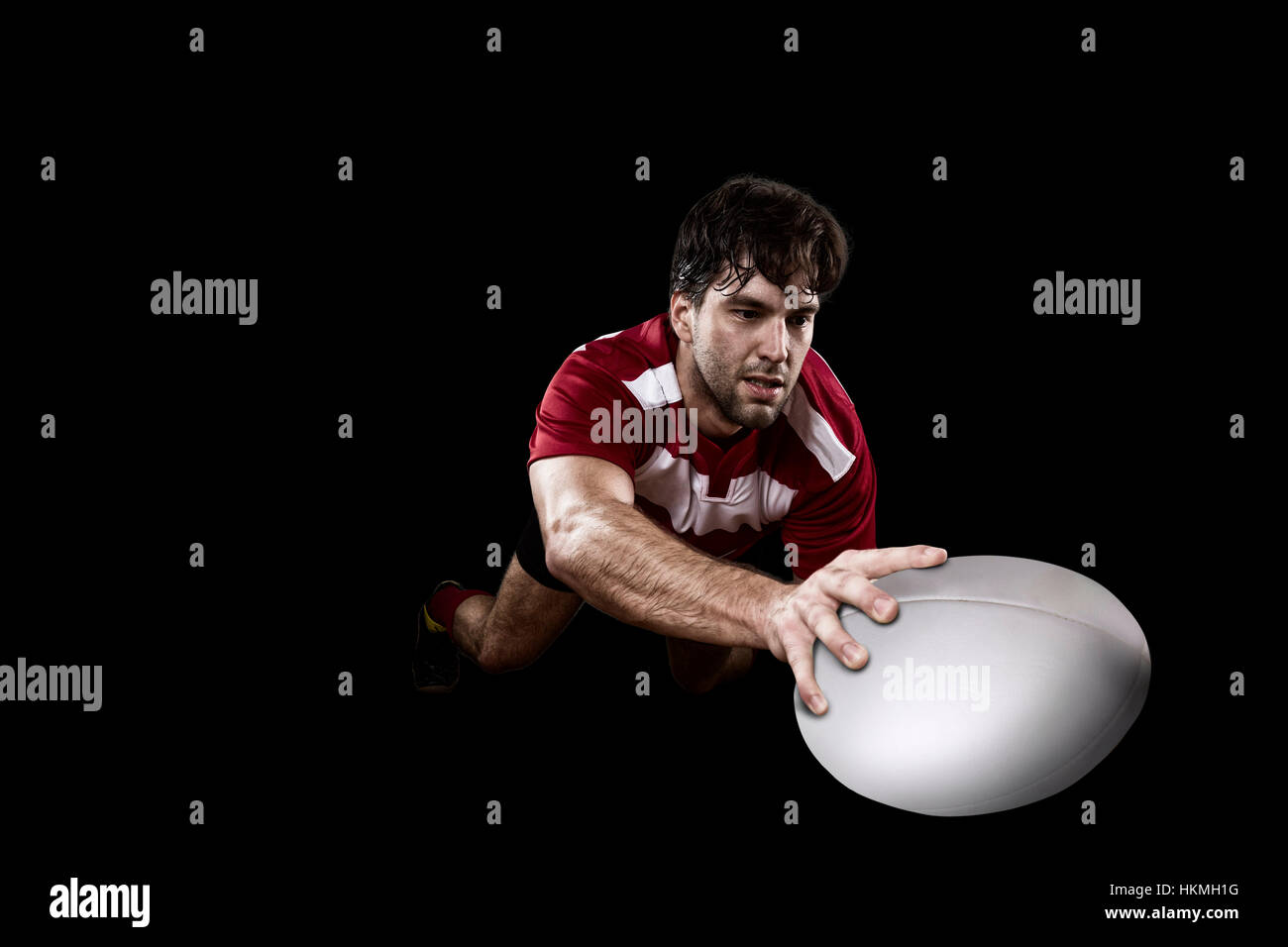 Rugby player in a red uniform. Black Background Stock Photo - Alamy