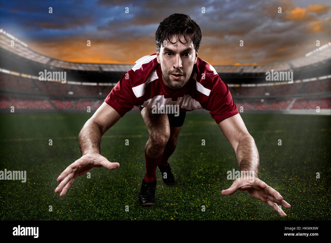 Rugby player in a red uniform giving a tackle. White Background Stock ...