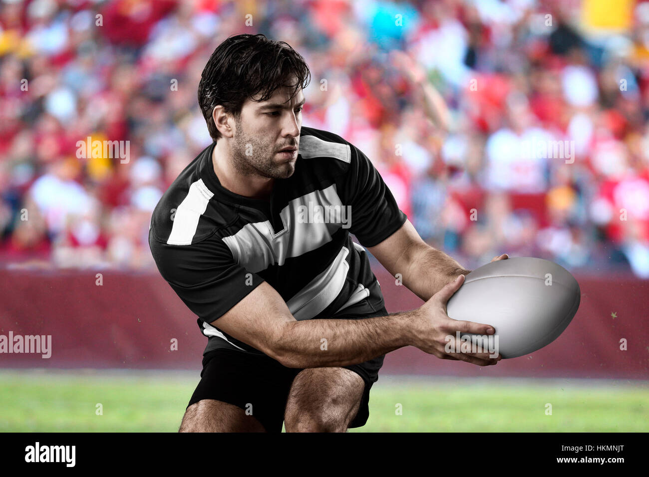 Rugby player in a black and white uniform on a stadium Stock Photo - Alamy