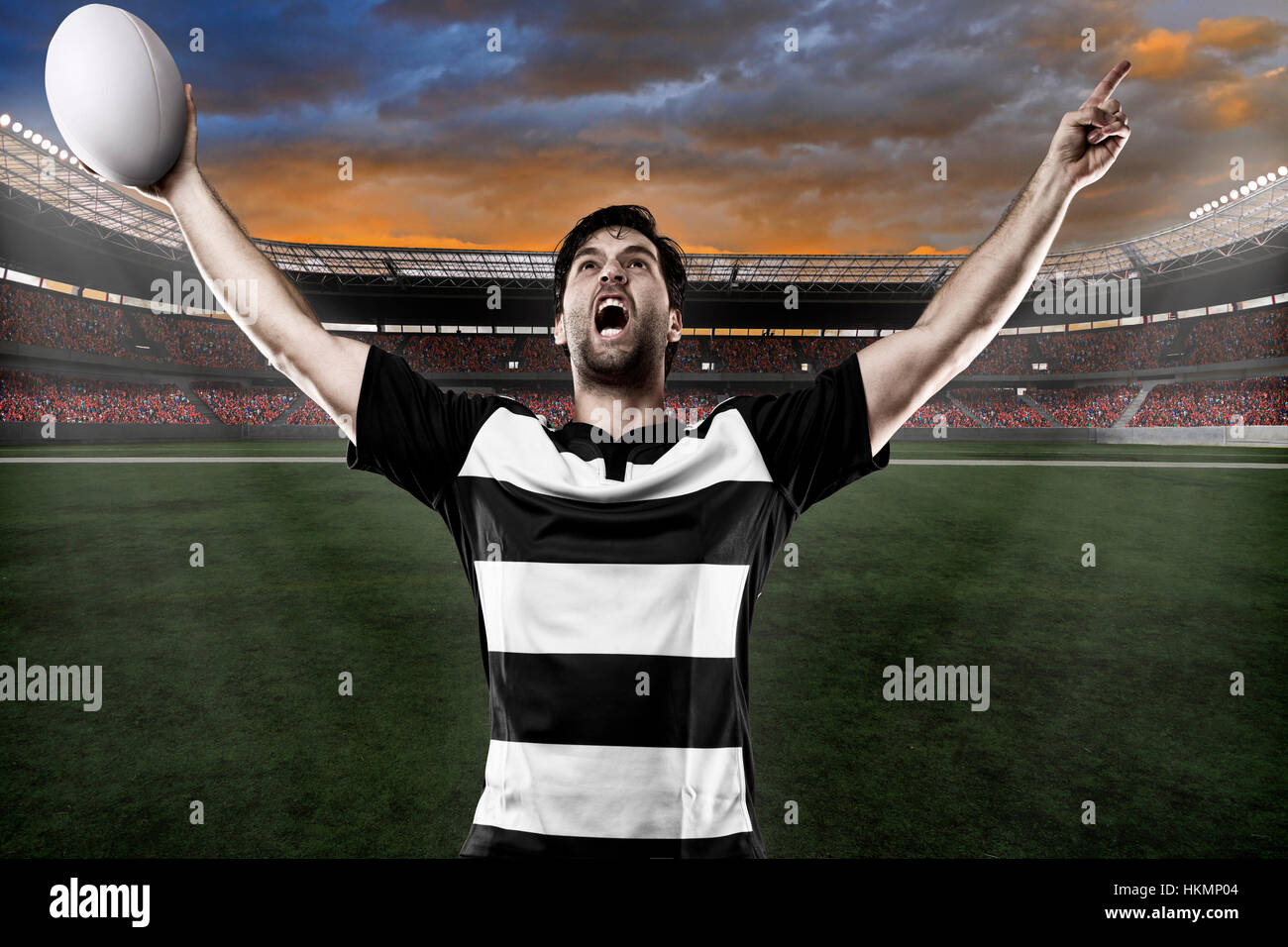 Rugby player in a black and white uniform celebrating on a stadium ...