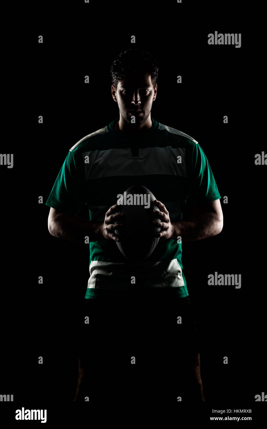 Rugby player in a green uniform. Black Background Stock Photo - Alamy