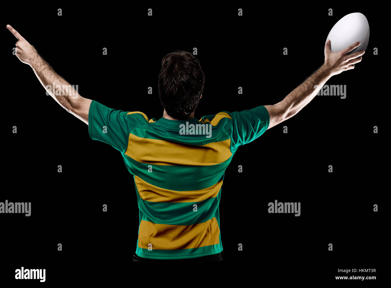 Rugby player in a green and gold uniform celebrating. Black Background ...
