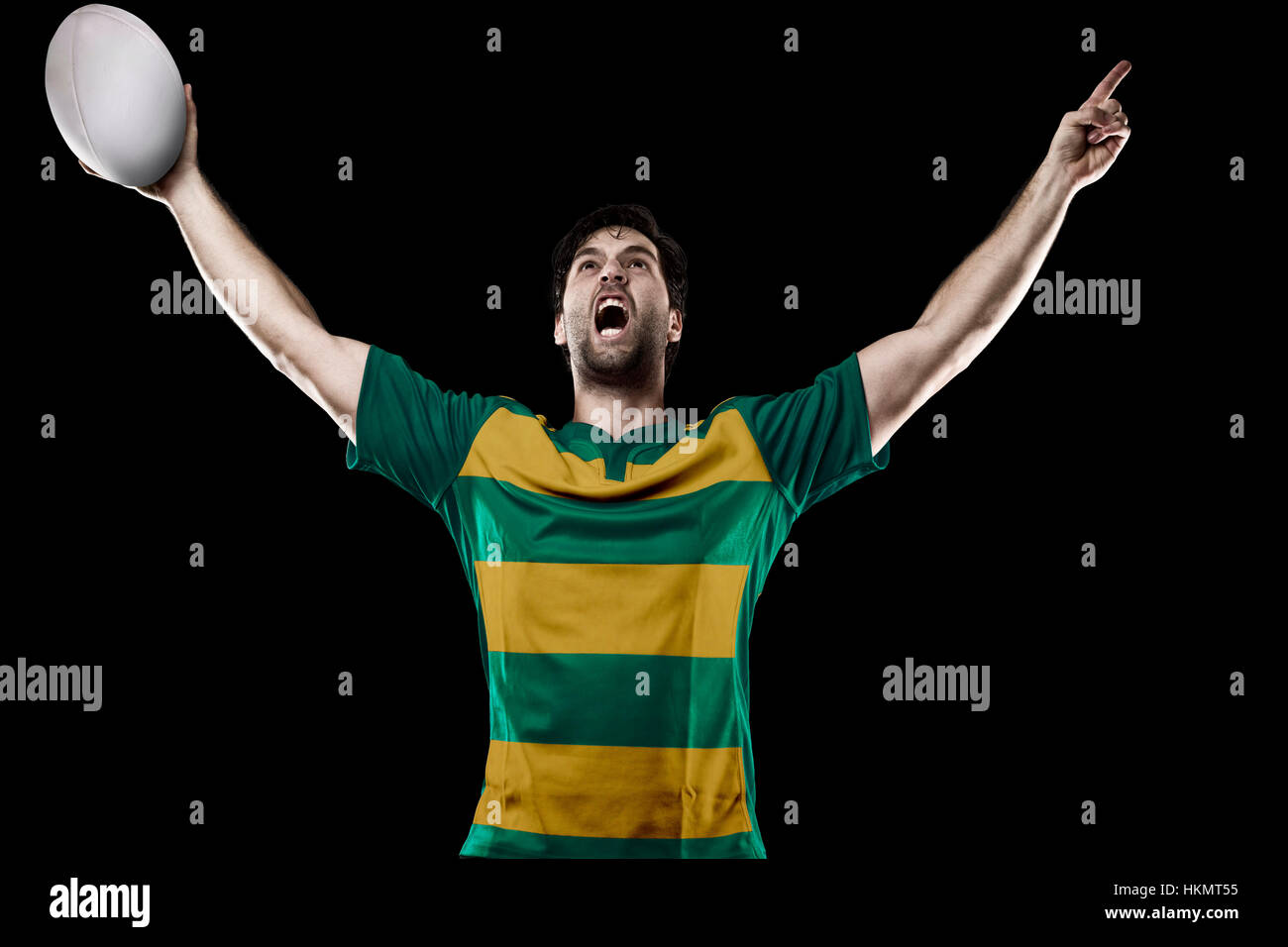 Rugby player in a green and gold uniform celebrating. Black Background ...