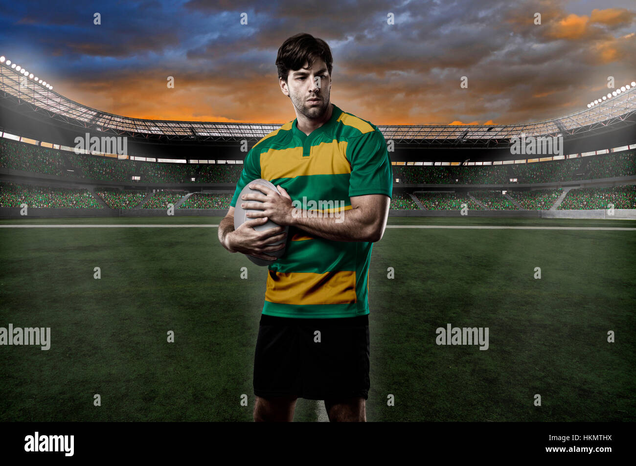Rugby player in a green and gold uniform on a stadium Stock Photo - Alamy