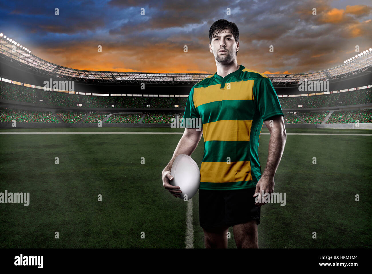 Rugby player in a green and gold uniform on a stadium Stock Photo - Alamy