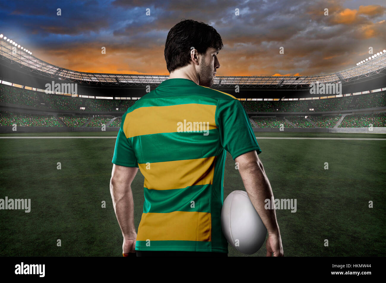 Rugby player in a green and gold uniform on a stadium Stock Photo - Alamy
