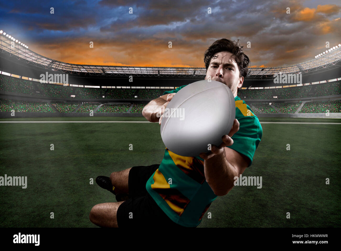 Rugby player in a green and gold uniform on a stadium Stock Photo - Alamy