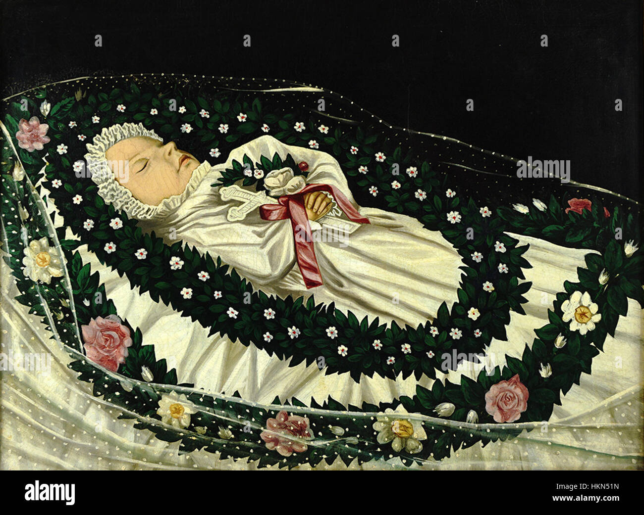 This poignant early 20th-century photograph depicts a child laid out in ...