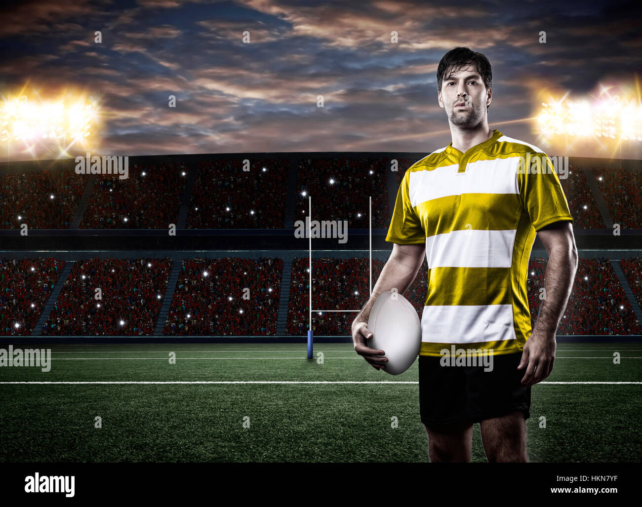 Rugby player in a yellow uniform on a stadium Stock Photo - Alamy