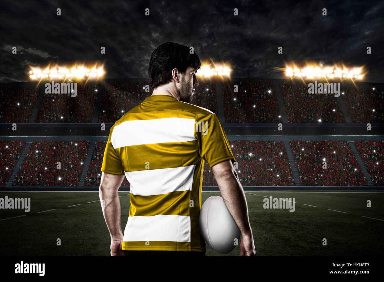 Rugby player in a yellow uniform on a stadium Stock Photo - Alamy