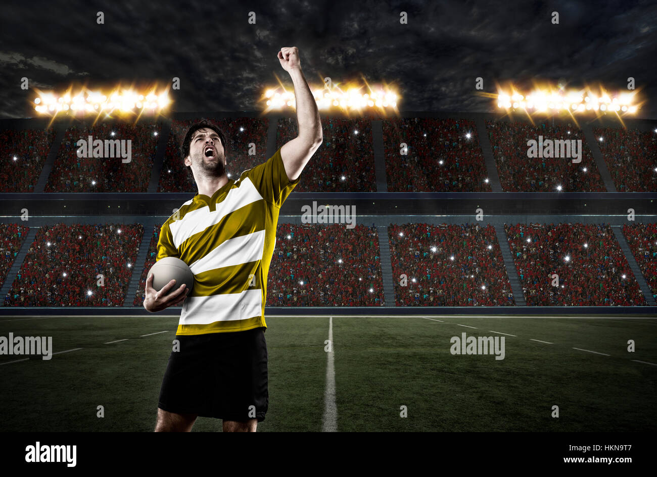 Rugby player in a yellow uniform celebrating on a stadium Stock Photo ...