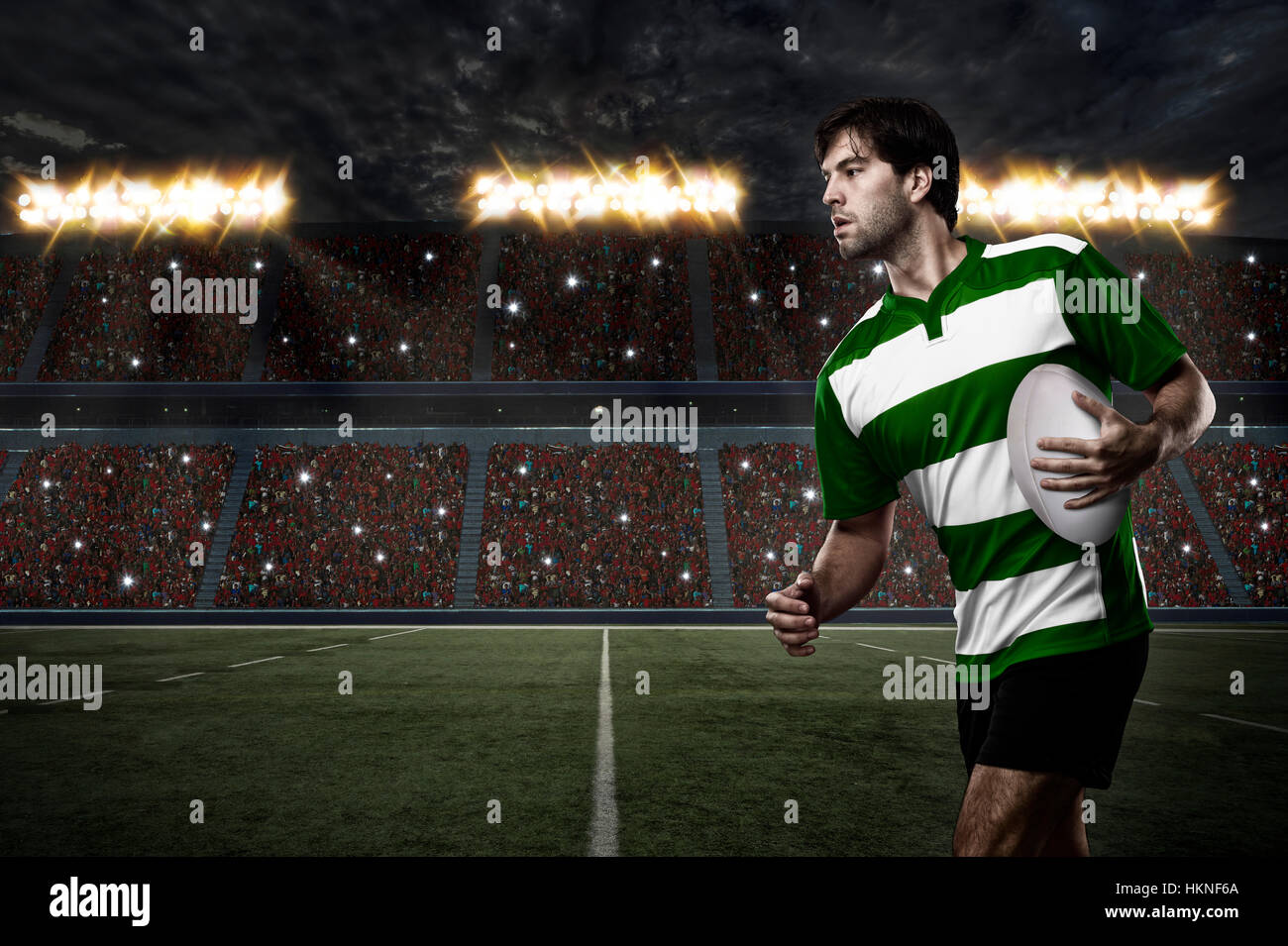 Rugby player in a green uniform on a stadium Stock Photo - Alamy