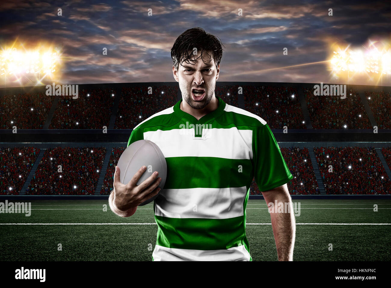 Rugby player in a green uniform on a stadium Stock Photo - Alamy