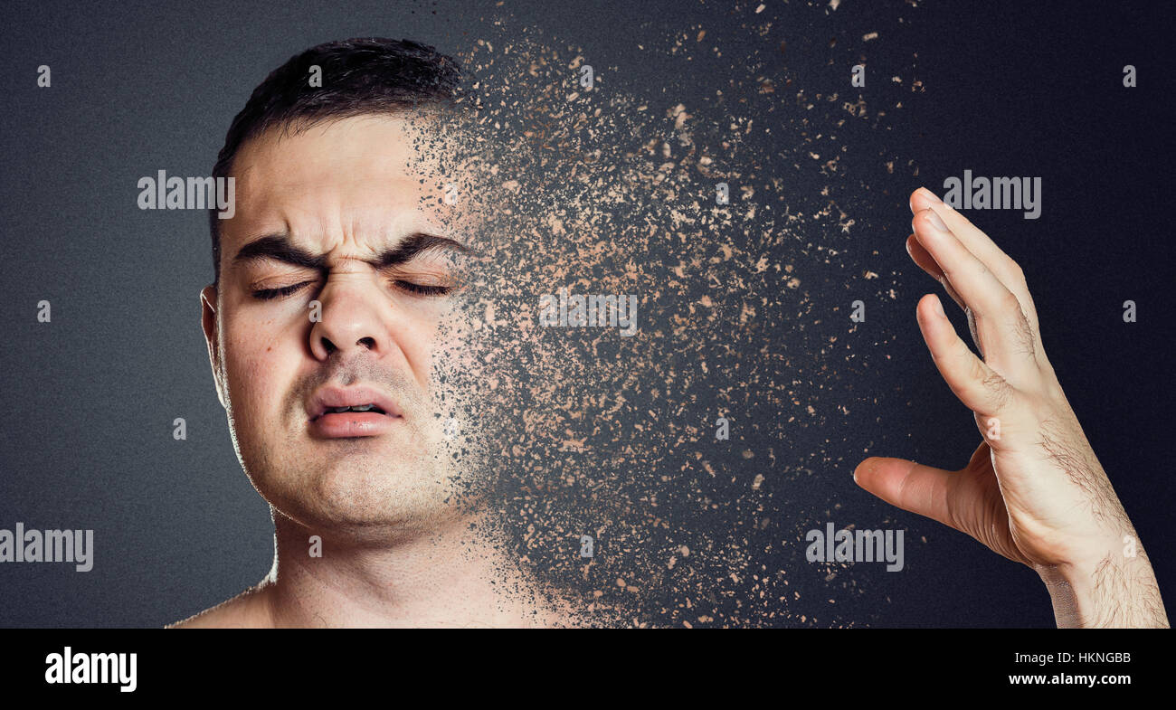 Depressive man dissolving his face into pieces. Mental health concept ...