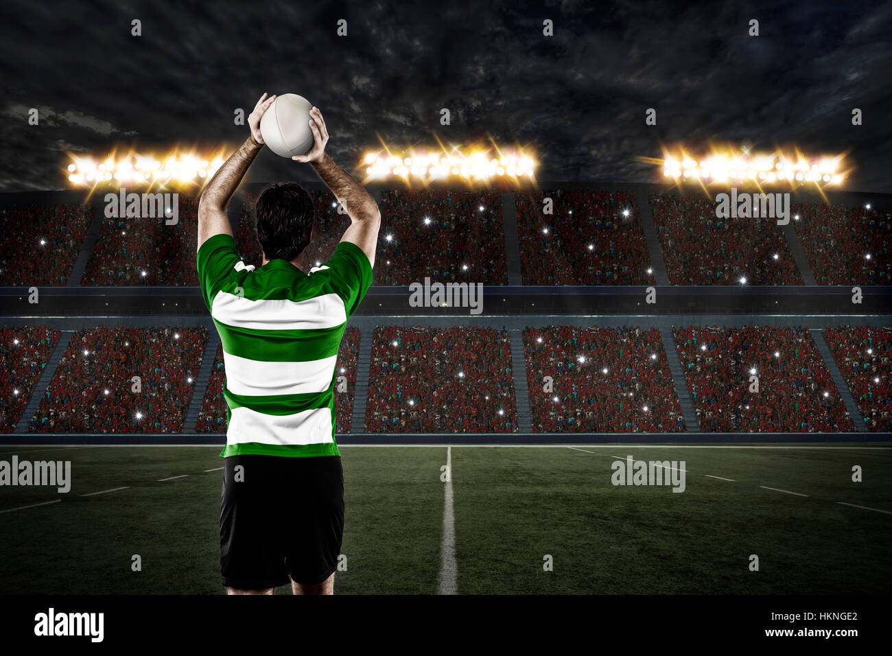 Rugby player in a green uniform on a stadium Stock Photo - Alamy