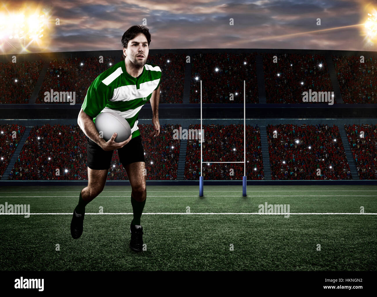 Rugby player in a green uniform running on a stadium Stock Photo - Alamy