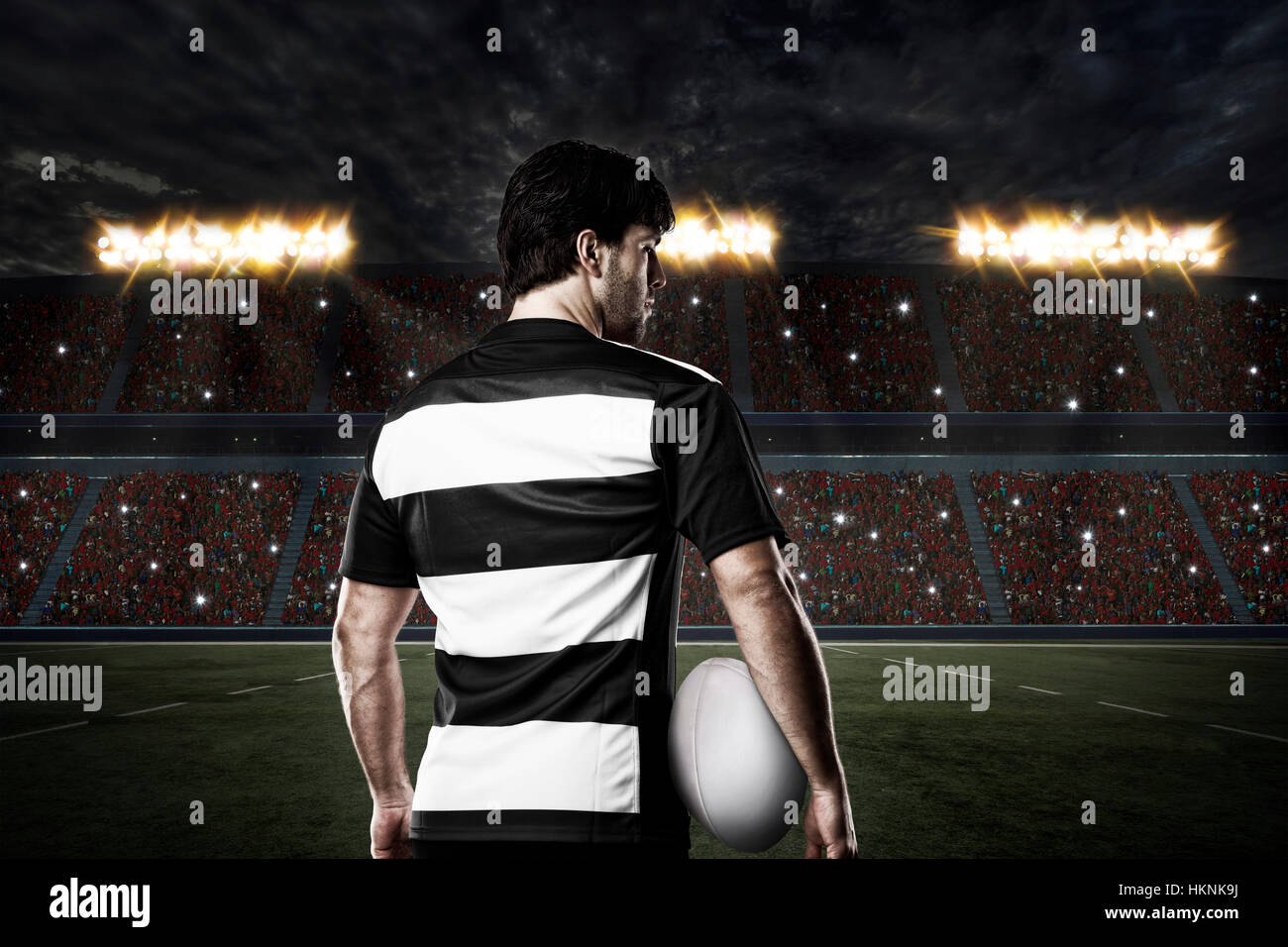 Rugby player in a black uniform on a stadium Stock Photo - Alamy