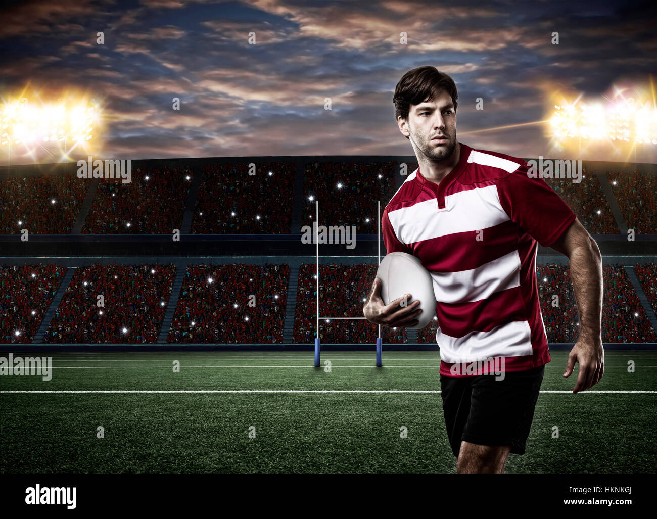 Rugby player in a red uniform on a stadium Stock Photo - Alamy