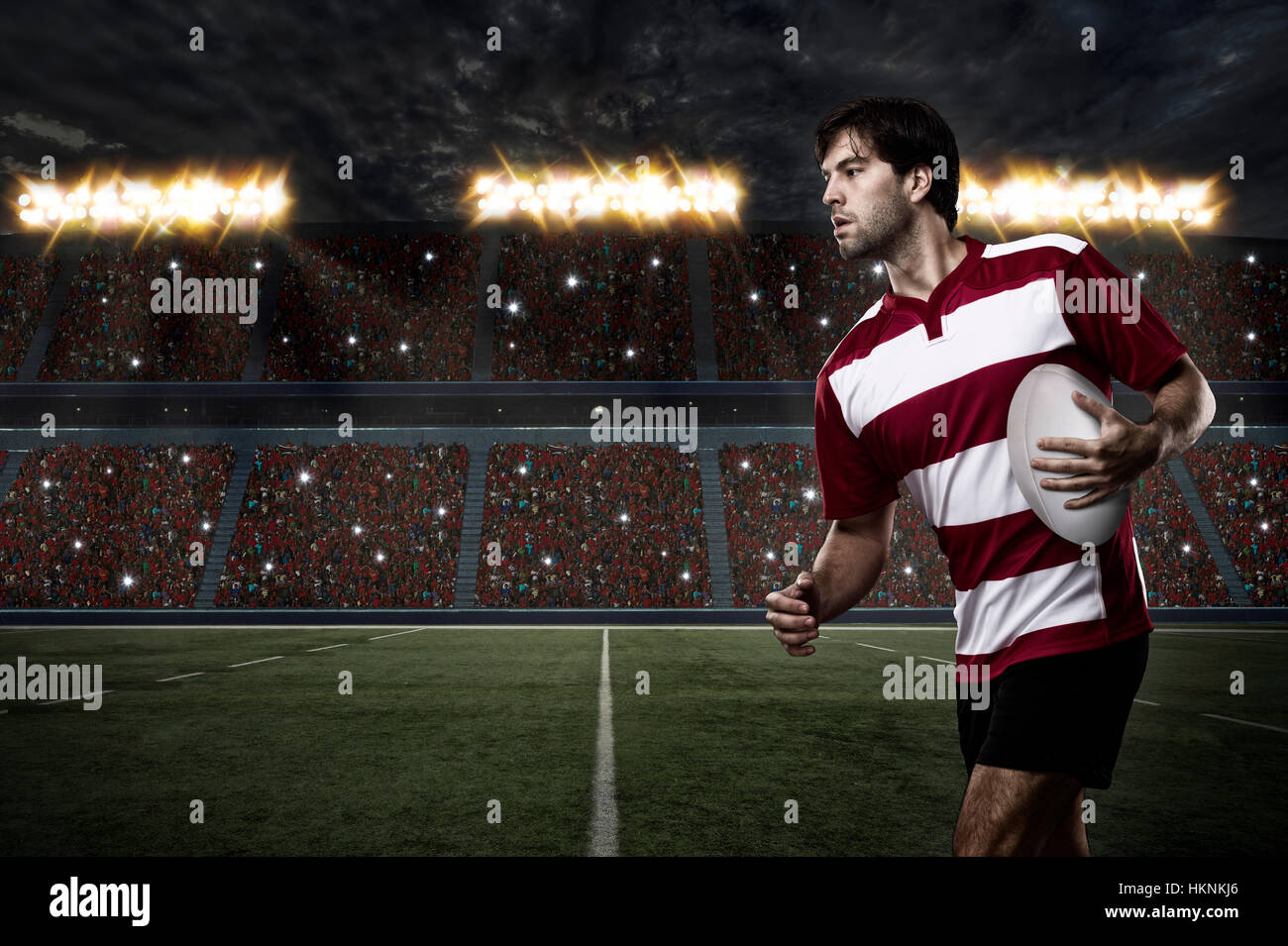 Rugby player in a red uniform on a stadium Stock Photo - Alamy