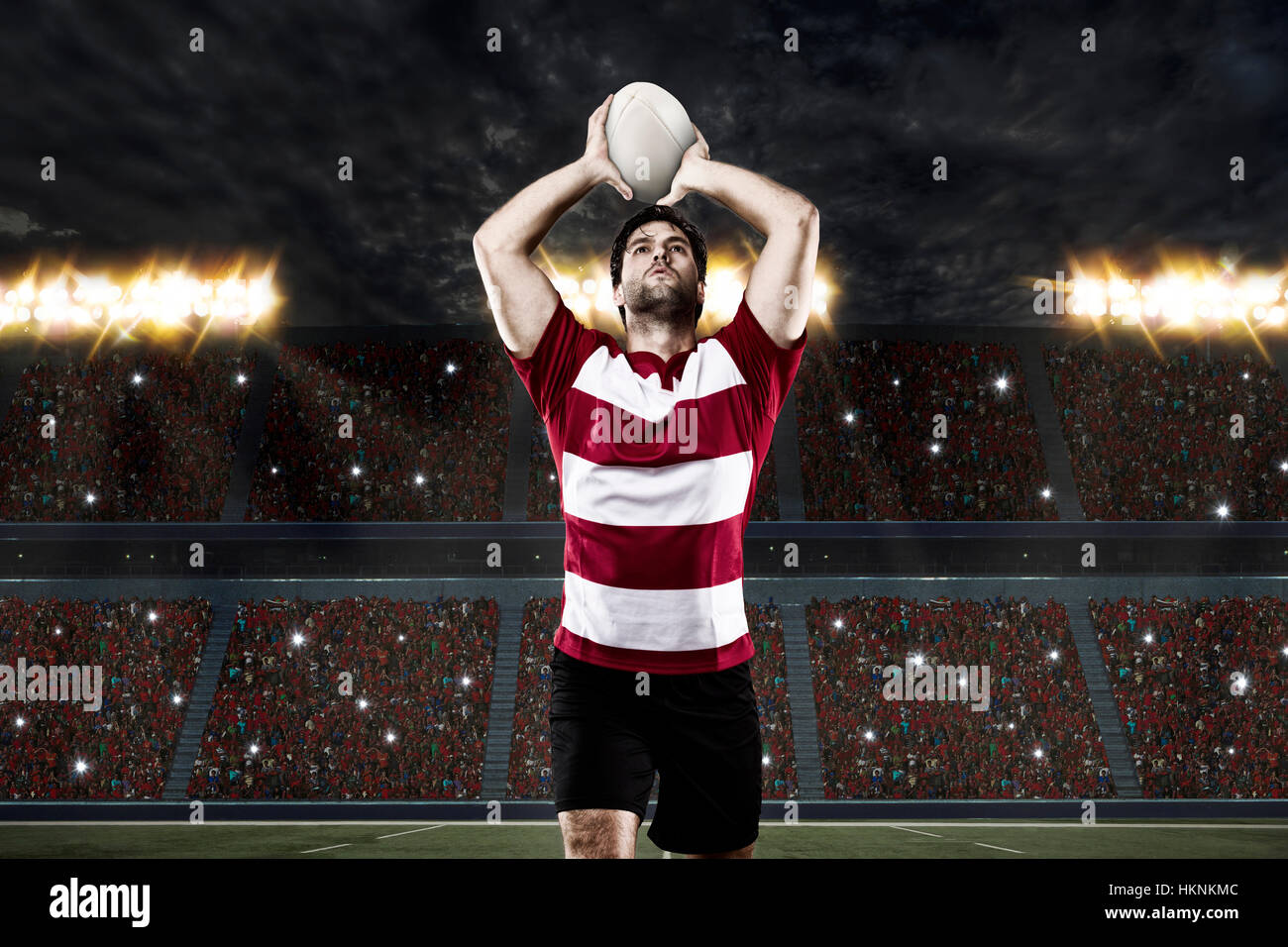 Rugby player in a red uniform on a stadium Stock Photo - Alamy