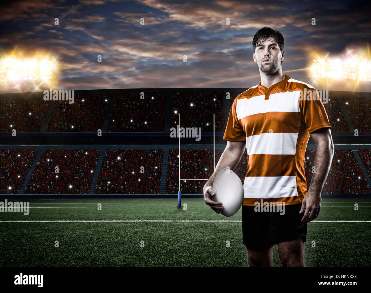 Rugby player in a orange uniform on a stadium Stock Photo - Alamy