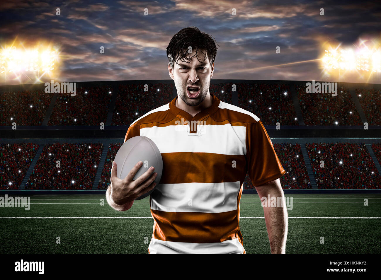 Rugby player in a orange uniform on a stadium Stock Photo - Alamy
