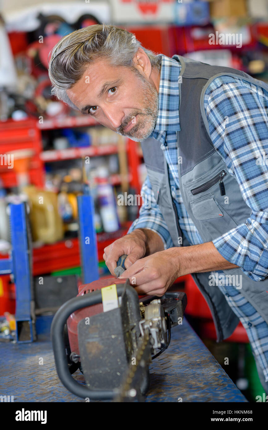 reassembling the chainsaw Stock Photo - Alamy