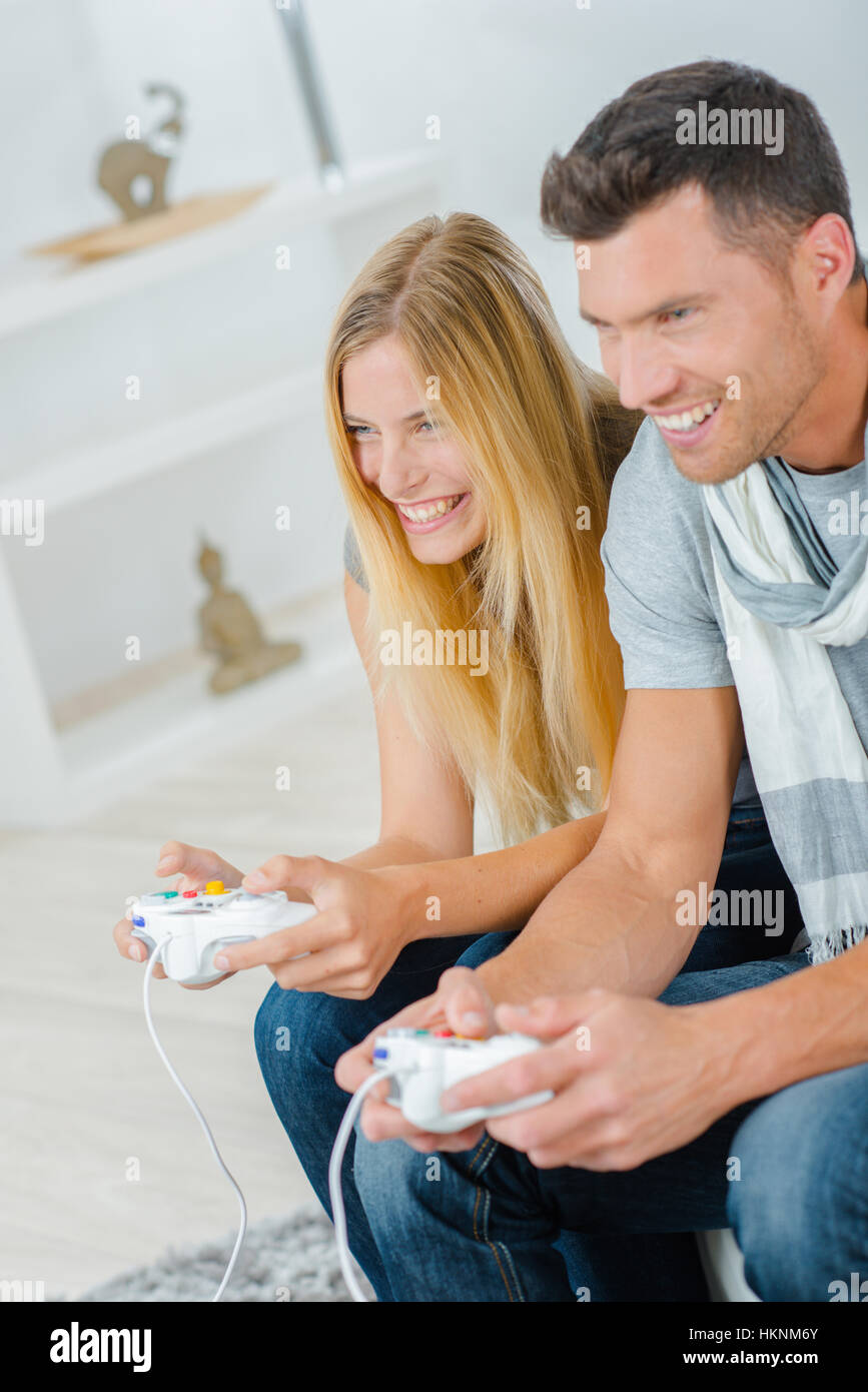 Couple playing computer game at home Stock Photo - Alamy