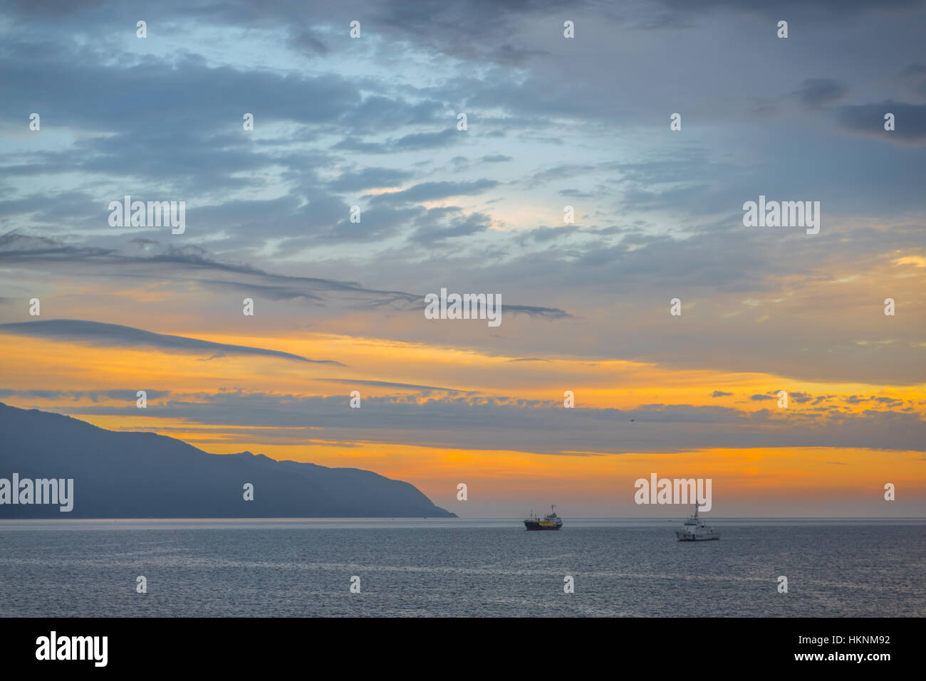 Two ships sailing in the sea of japan during sunrise Stock Photo - Alamy