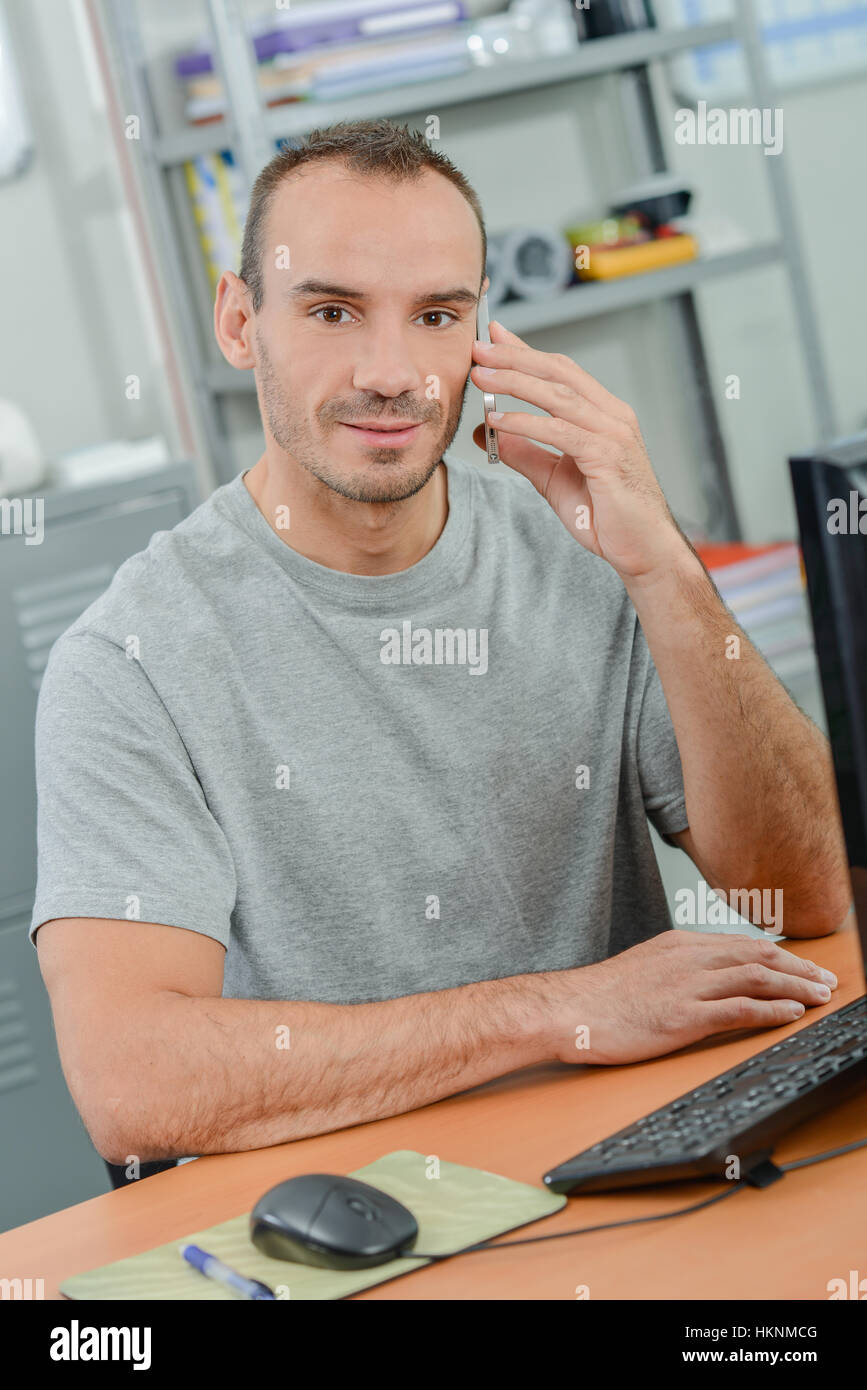 Man using his mobile at the office Stock Photo - Alamy