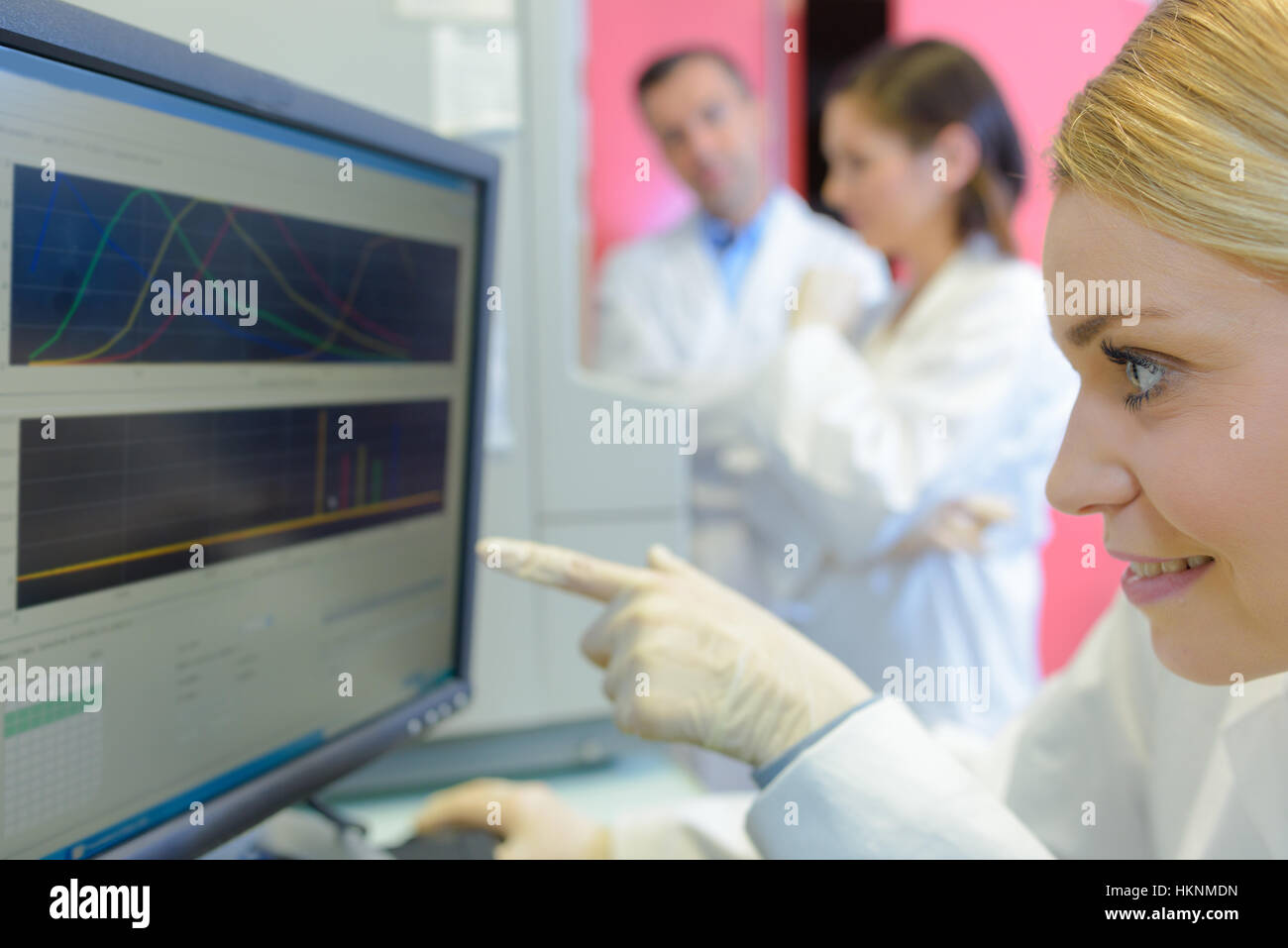 Female medic looking at graph on computer Stock Photo - Alamy