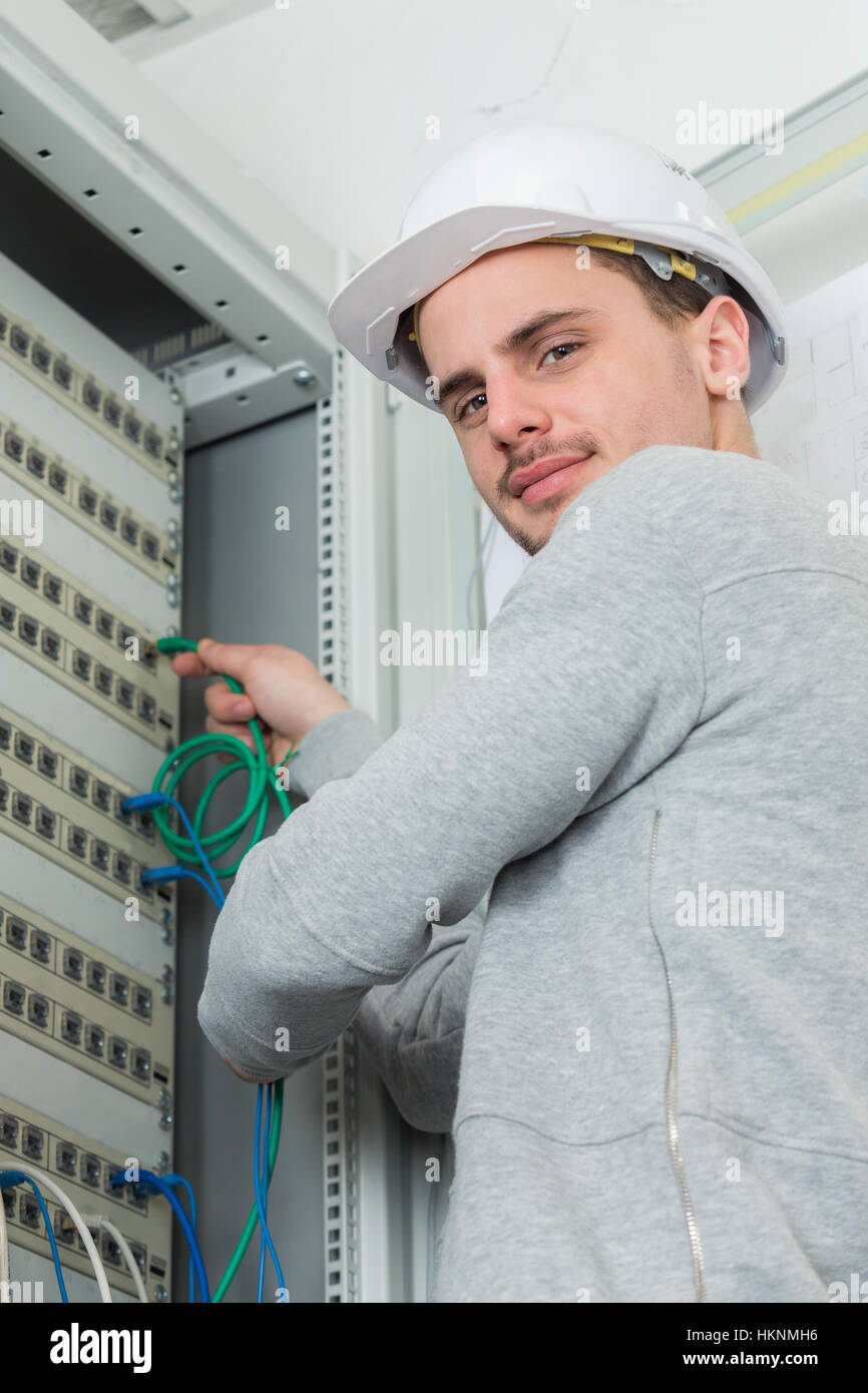 young professional electrician at work in building Stock Photo - Alamy
