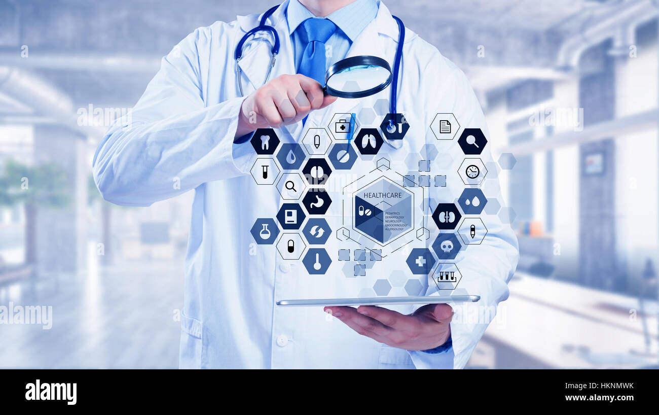 Close of man doctor holdig tablet and medical user interface. Mixed ...