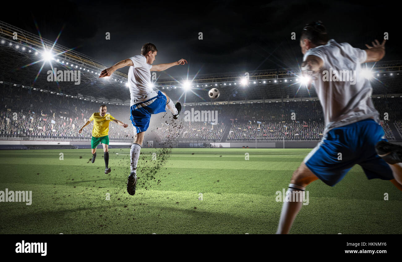Soccer players in action on stadium fighting for ball. Mixed media ...