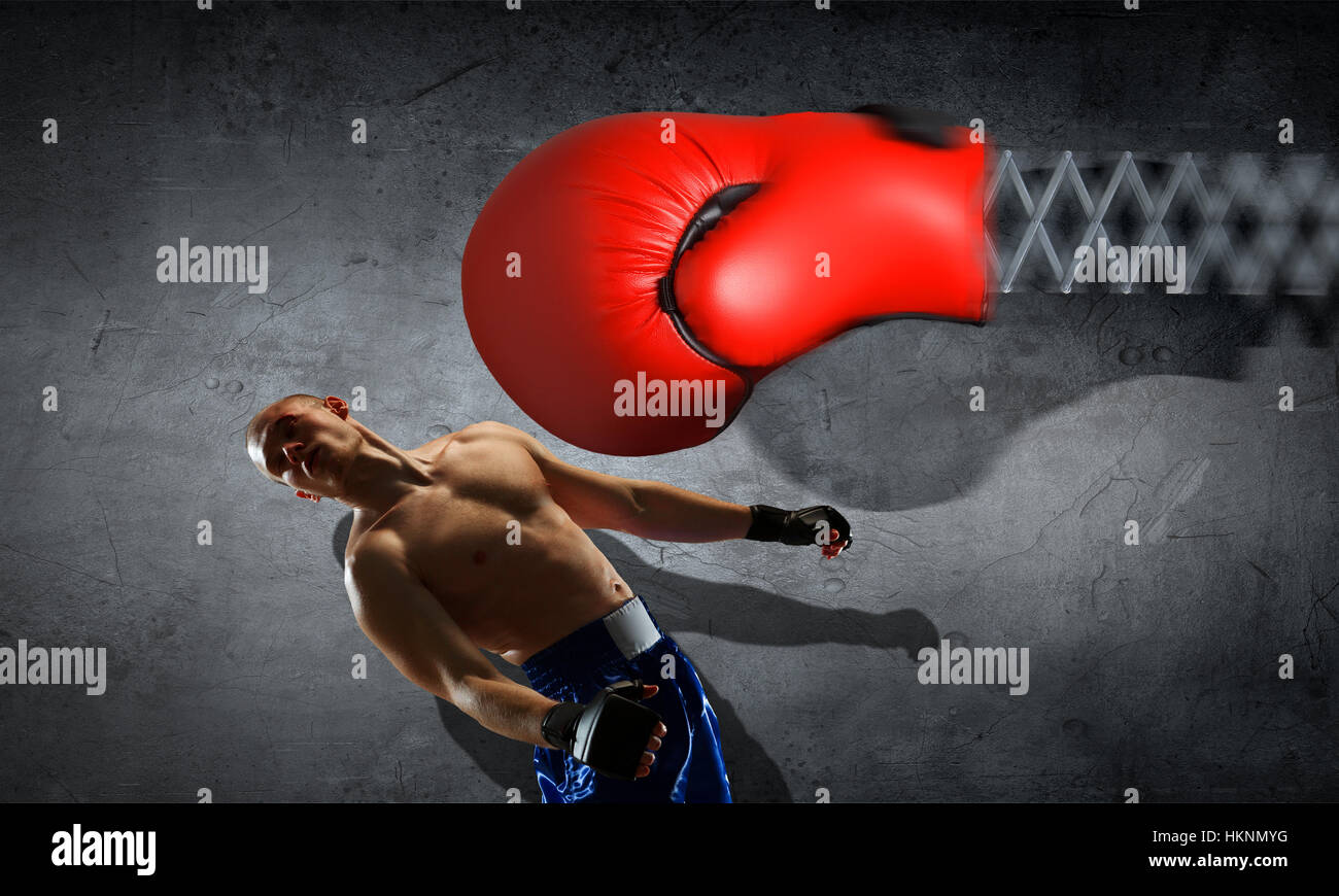 Young man boxing in empty concrete room Stock Photo - Alamy