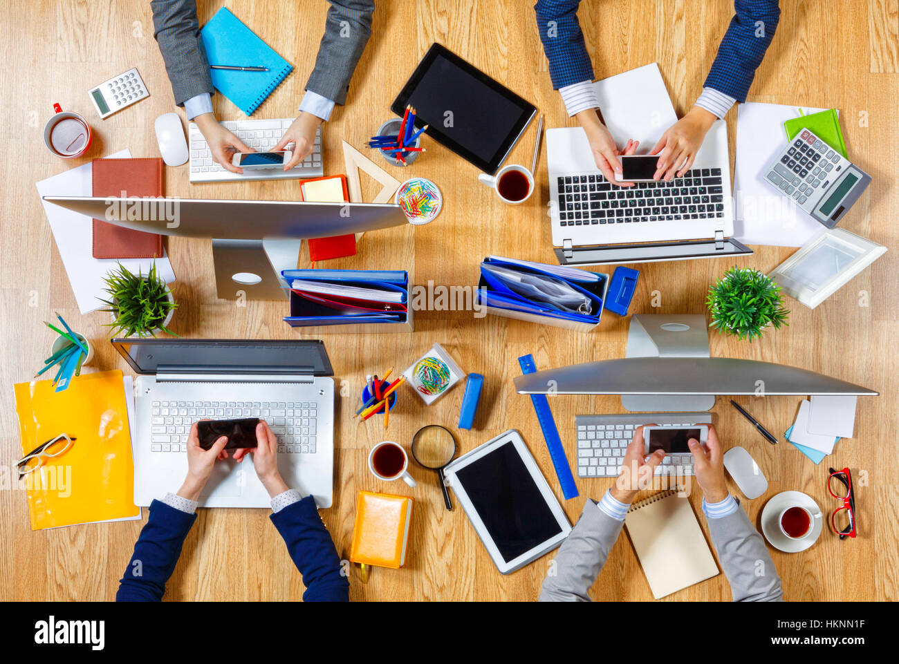 Top view of office table with four colleagues working together Stock ...