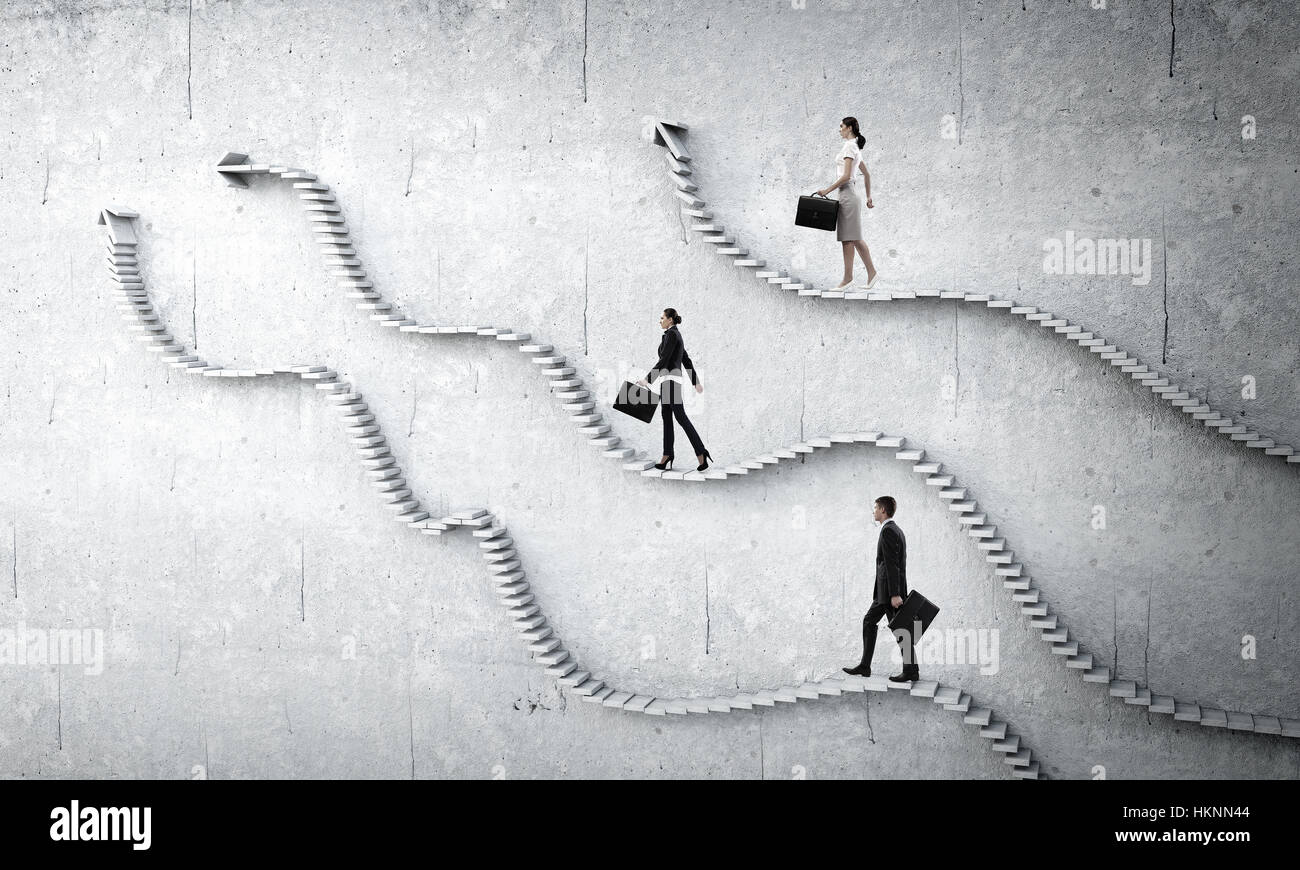 Young businesspeople reaching up staircase as symbol of growth and ...
