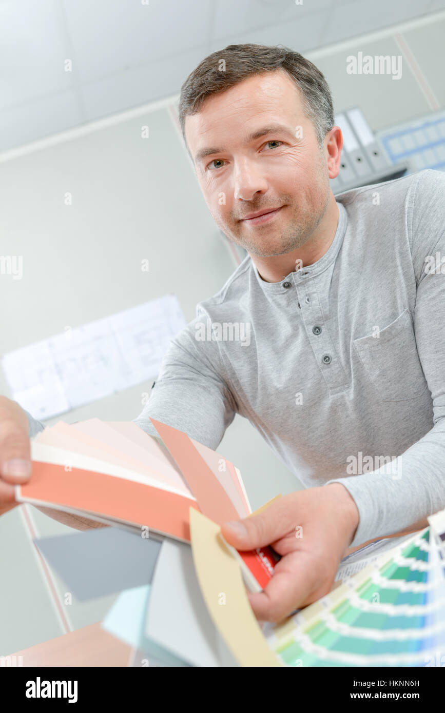 Man holding paint charts Stock Photo - Alamy