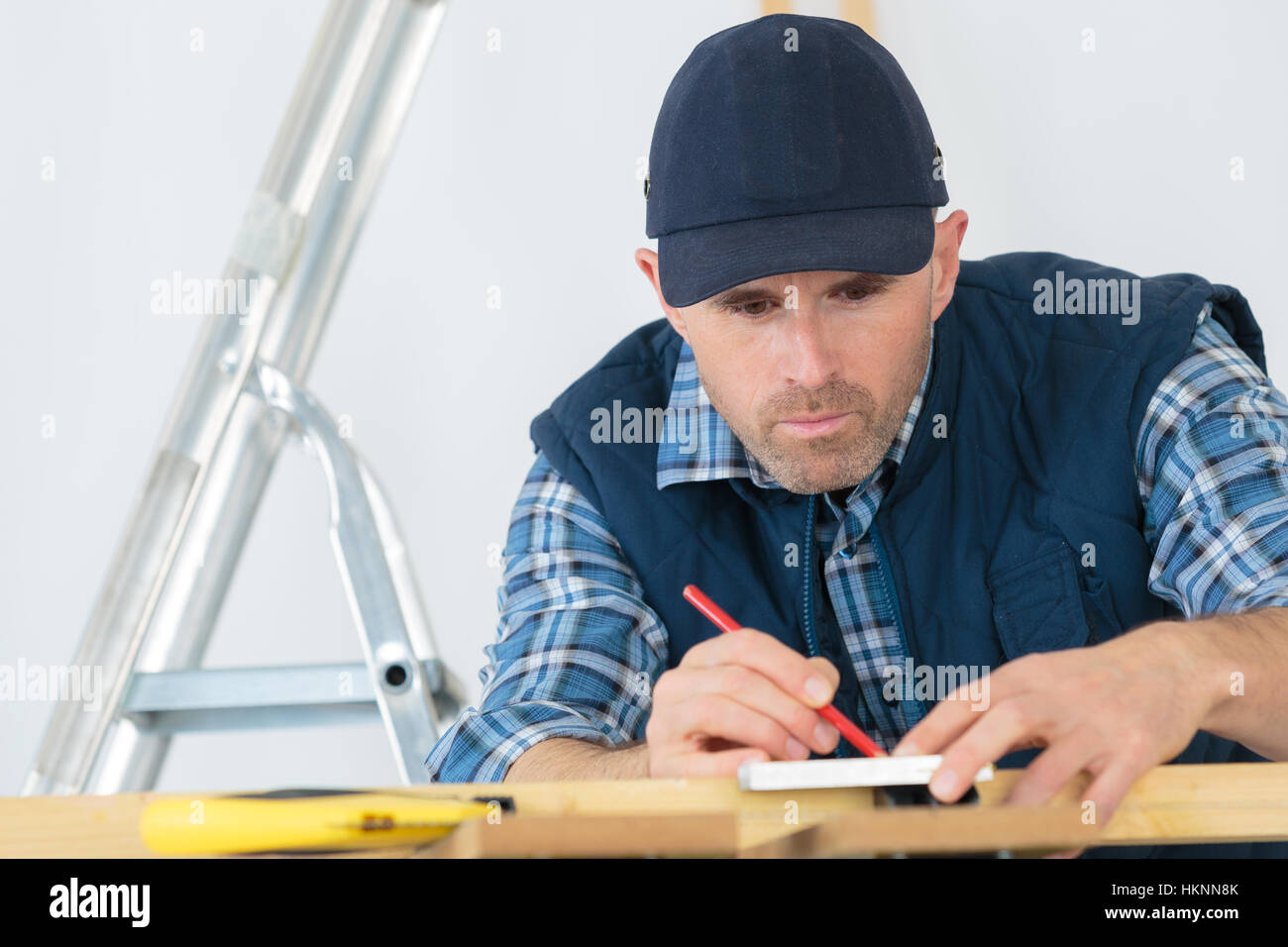 Tradesman marking wood Stock Photo - Alamy