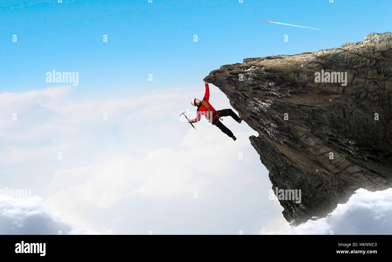 Young brave man alpinist climbing dangerous cliff Stock Photo - Alamy