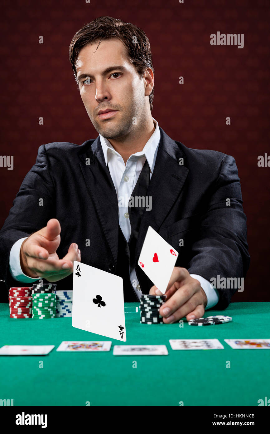 Poker player, on a red background, throwing two ace cards Stock Photo ...