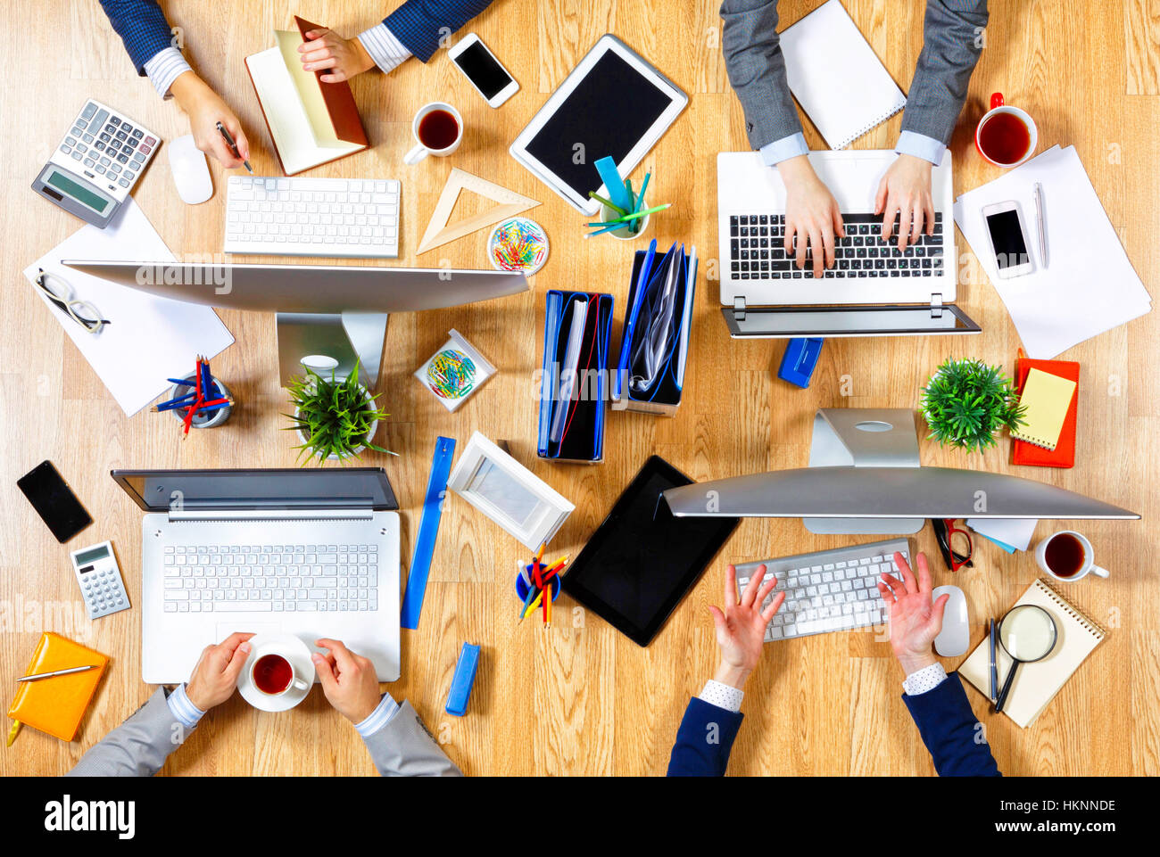Top view of office table with four colleagues working together Stock ...